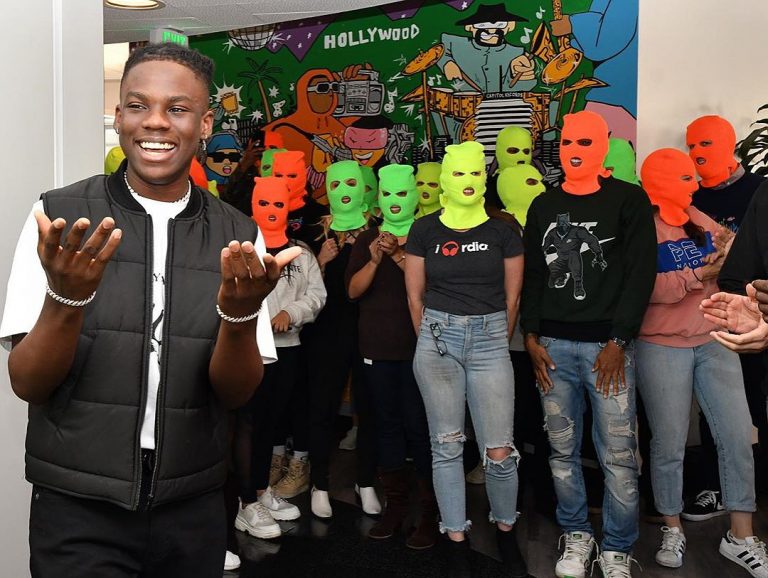 Music star REMA welcomed by US fans seen spotting his usual ski mask ...
